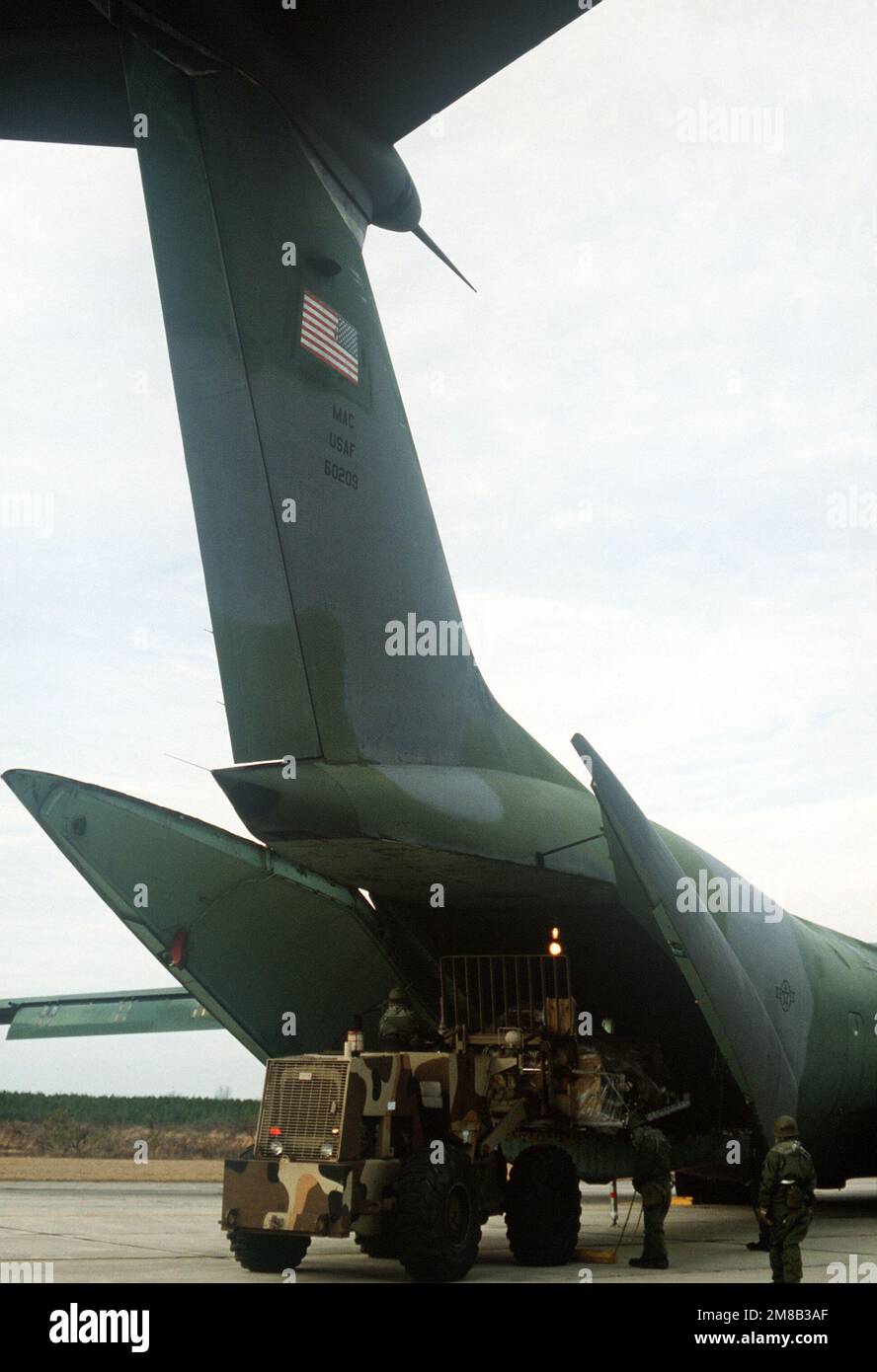 A member of the 437th Aerial Port Squadron uses a Case MW20BFL rough ...