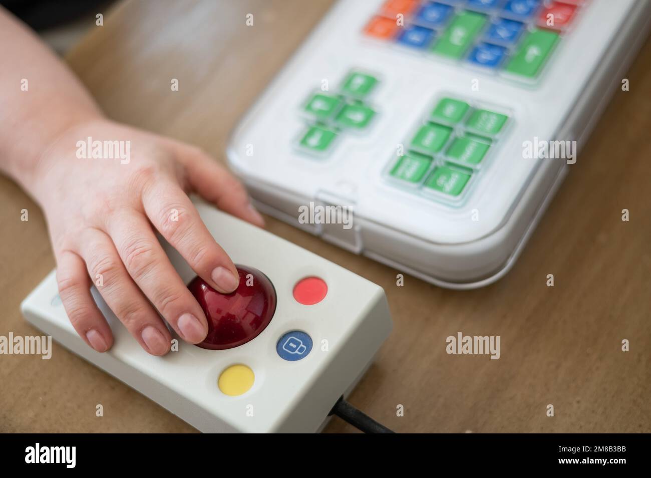 Woman with cerebral palsy works on a specialized computer mouse Stock ...