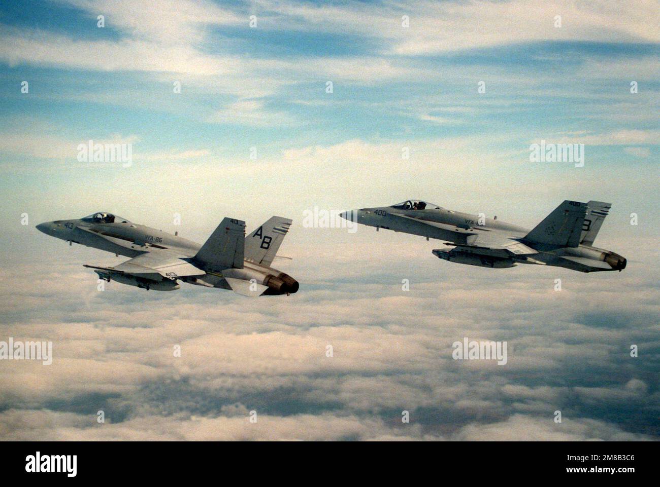 An air-to-air left side view of two Strike Fighter Squadron (VFA-86) F ...