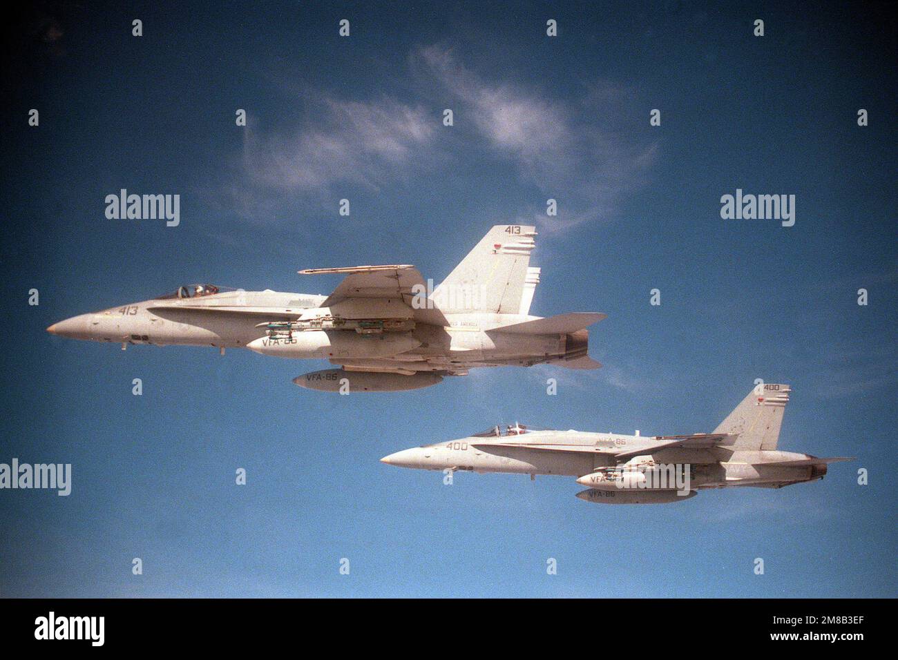 An air-to-air left side view of two Strike Fighter Squadron (VFA-86) F ...