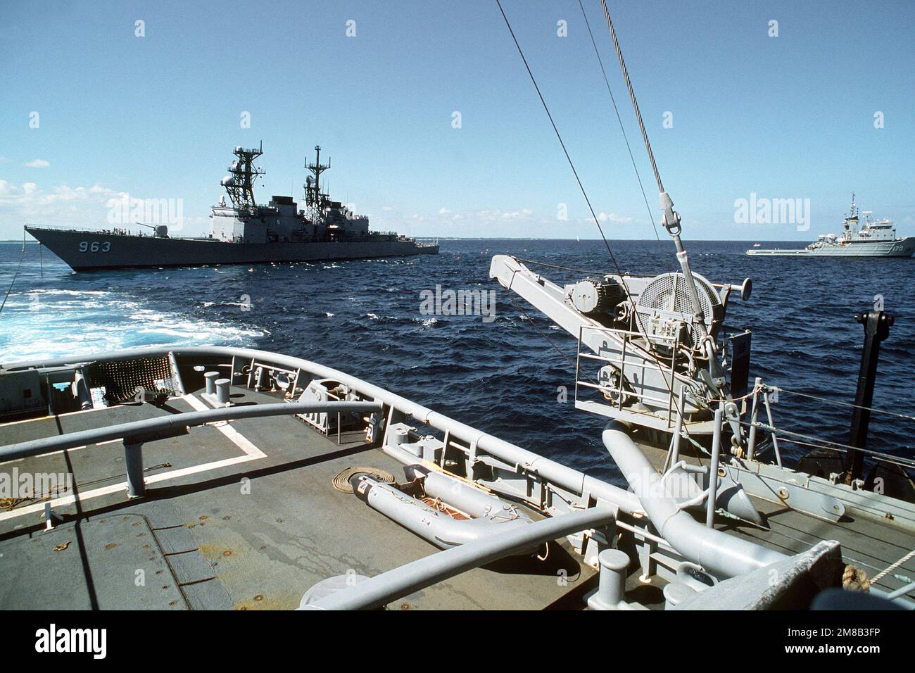 The salvage ship USS GRASP (ARS-51) keeps tension on the tow line ...