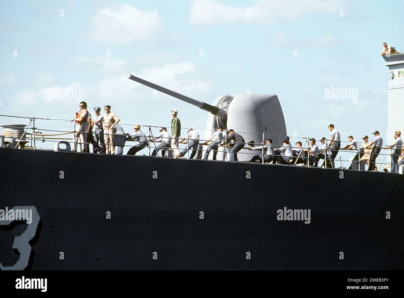 Crewmen on the deck of the destroyer USS SPRUANCE (DD-963) leave in the ...