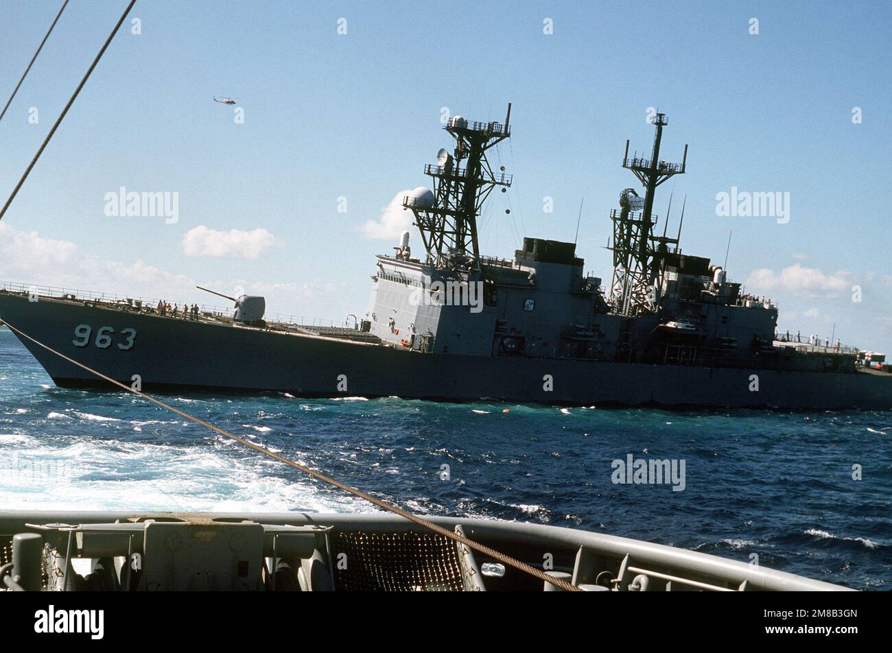 Crewmen on the deck of the Grounded destroyer USS SPRUANCE watch as the ...