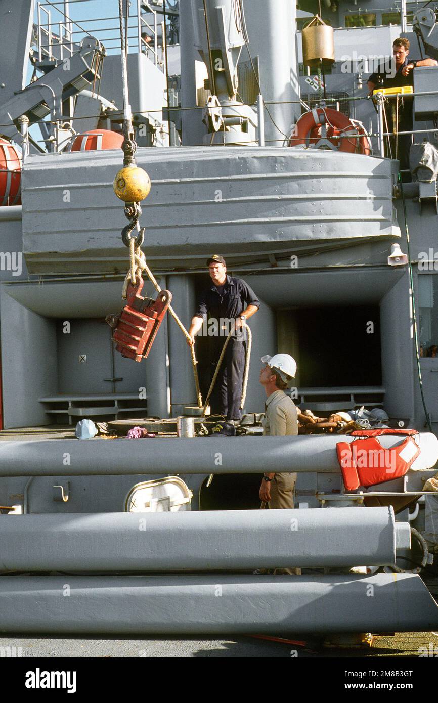 Crewmen hoist a carpenter's stopper from the salvage hold of the ...