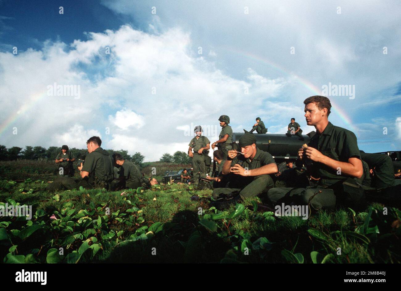 Seabees from Naval Mobile Construction Battalion 3 (NMCB-3) take a meal ...