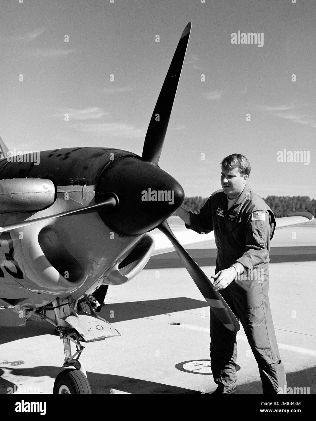 LTJG Brent Lebish student naval aviator, inspects the propeller of a T ...