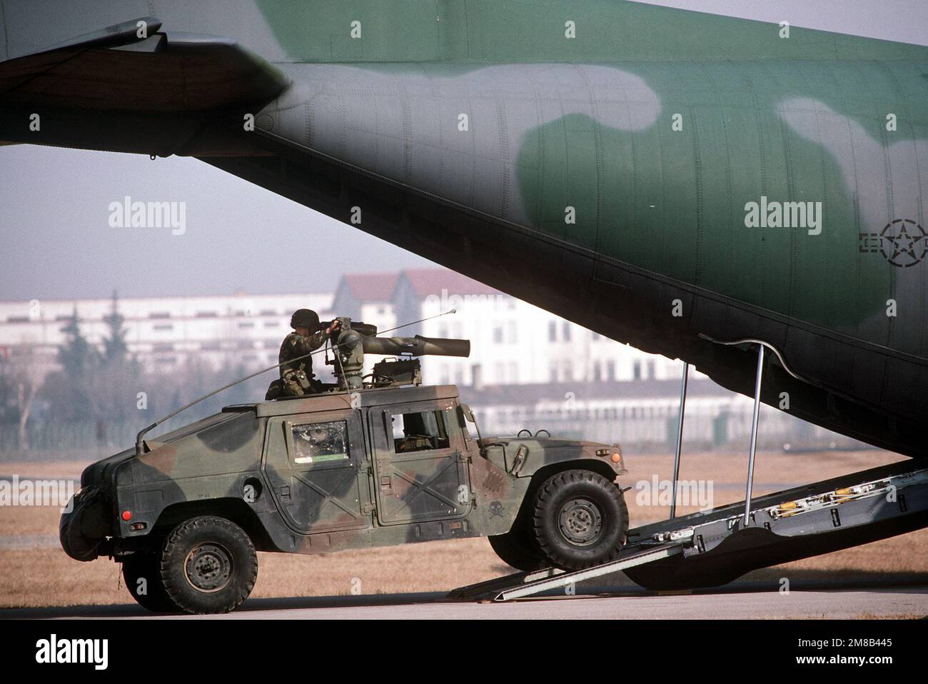 An M998 high mobility multipurpose wheeled vehicle carrying a tube ...