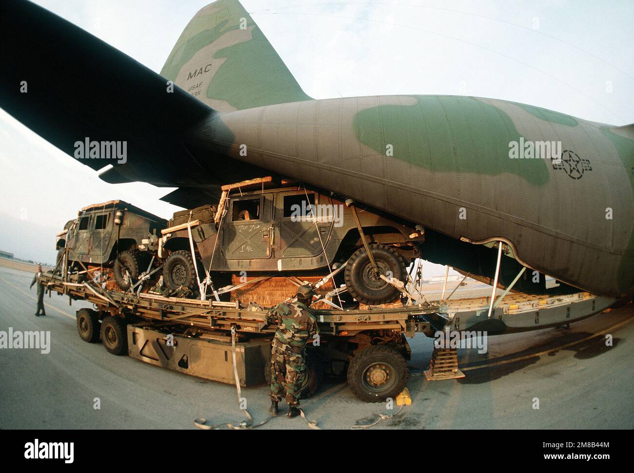 M998 High-Mobility Multipurpose Wheeled Vehicles (HMMWV) are loaded ...