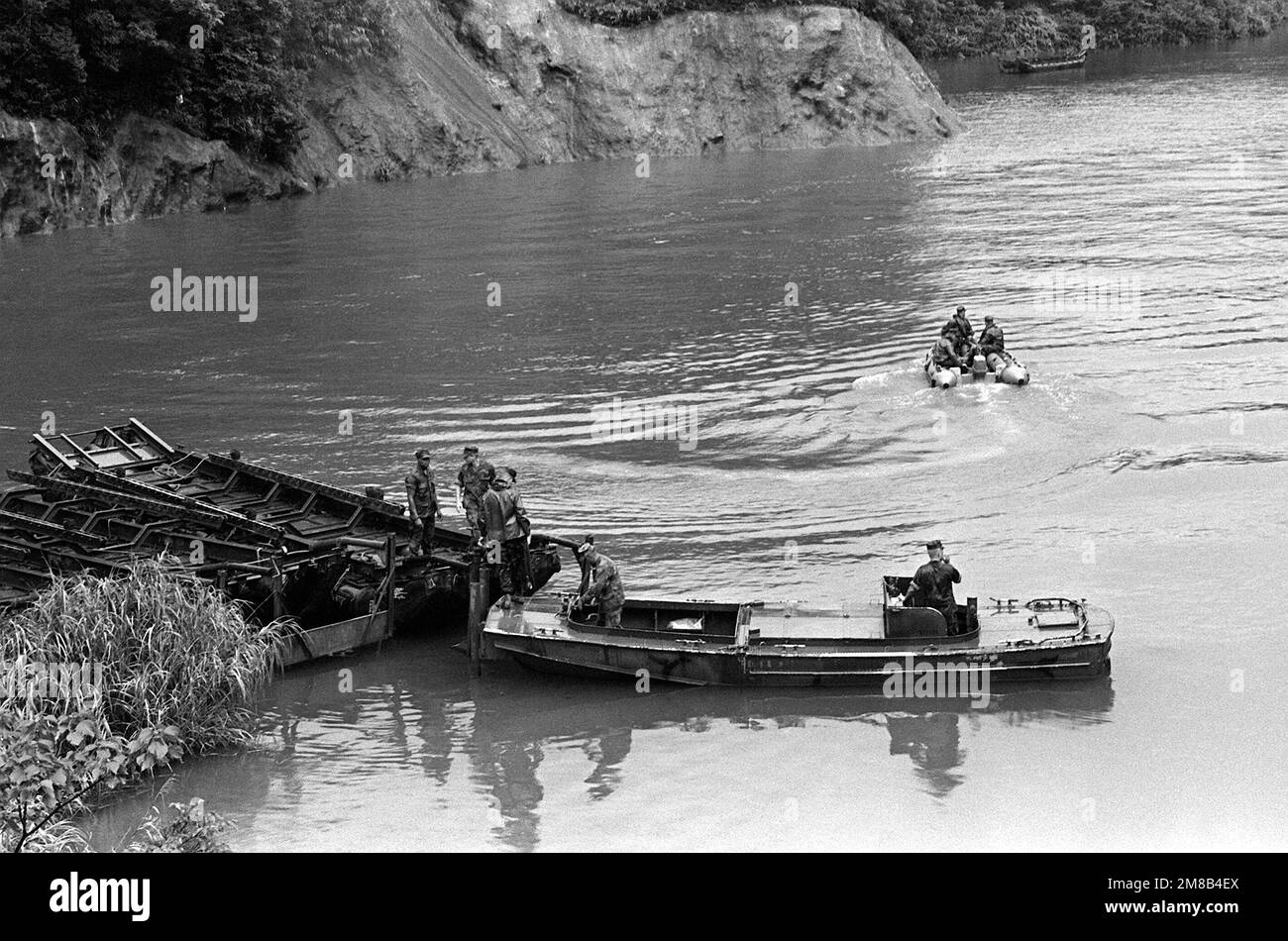 During a pontoon bridge assembly training exercise, two Marines on the ...