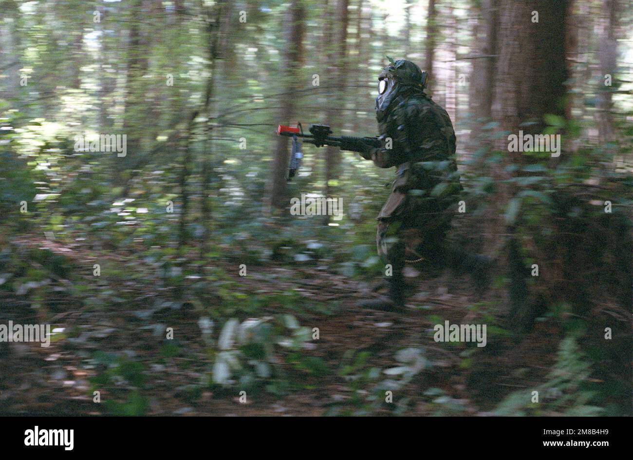 A student wearing a gas mask and Multiple Integrated Laser Engagement ...