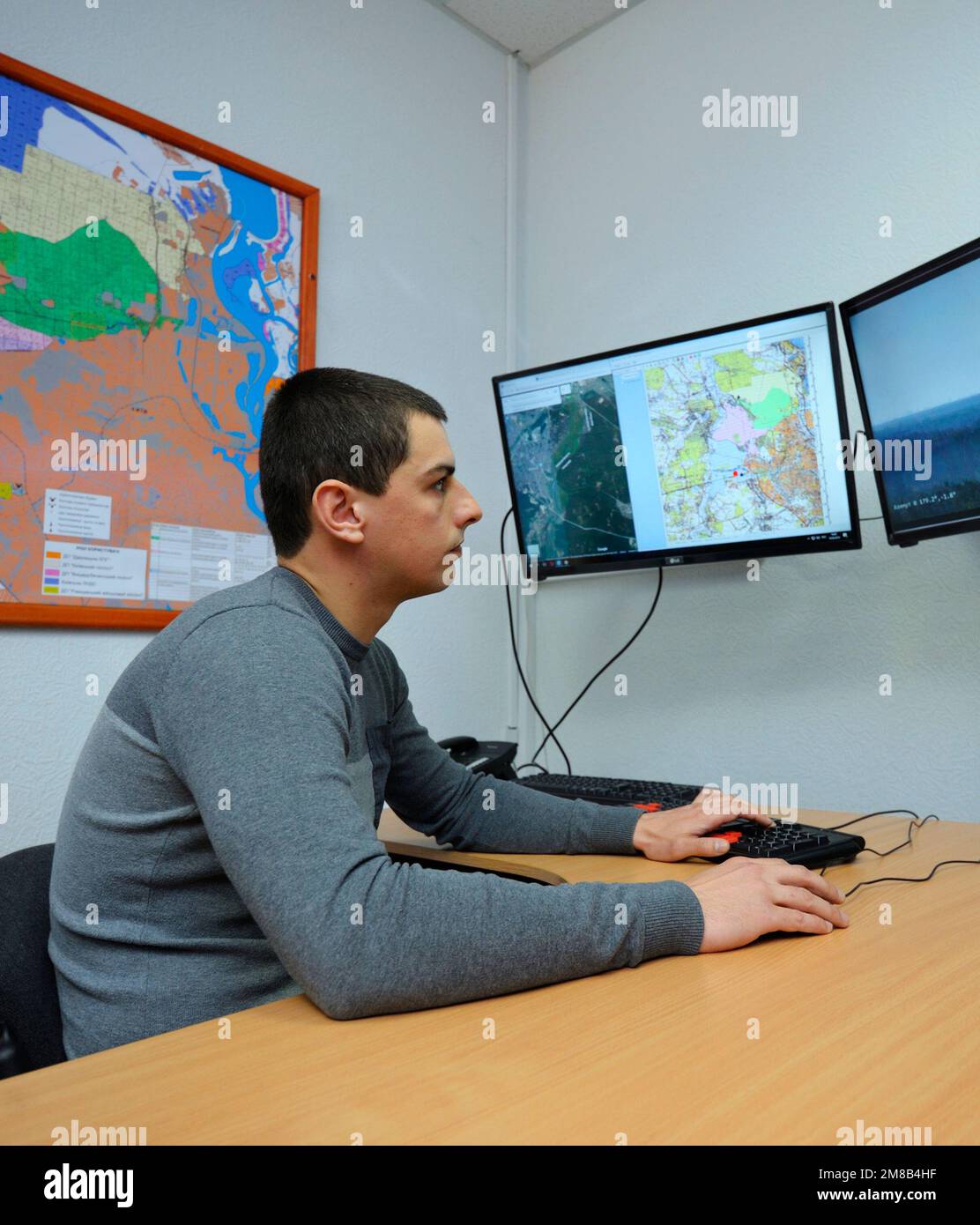 At the fire station video observation room: operator sitting in front ...