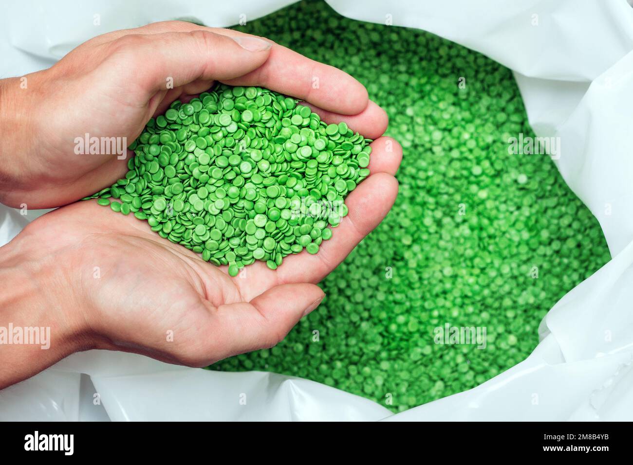 A hands hold or touching biodegradable plastic pellets, plastic polymer ...