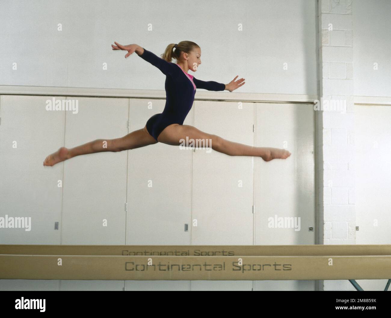 Gymnast leaping on a beam Stock Photo - Alamy