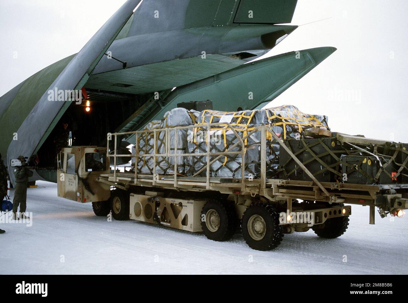 A K-loader carrying supplies and equipment backs away from a 437th ...