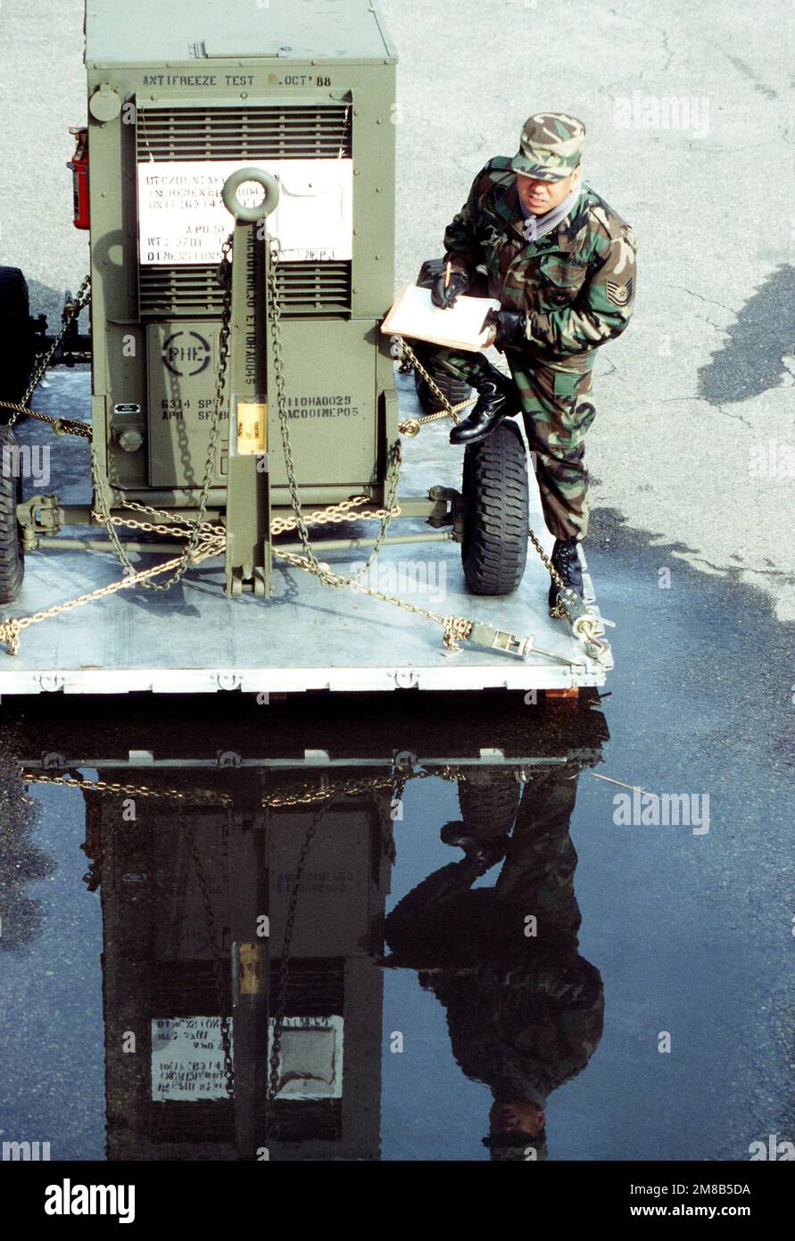A sergeant taking inventory records a unit of a Harvest Eagle tent city ...