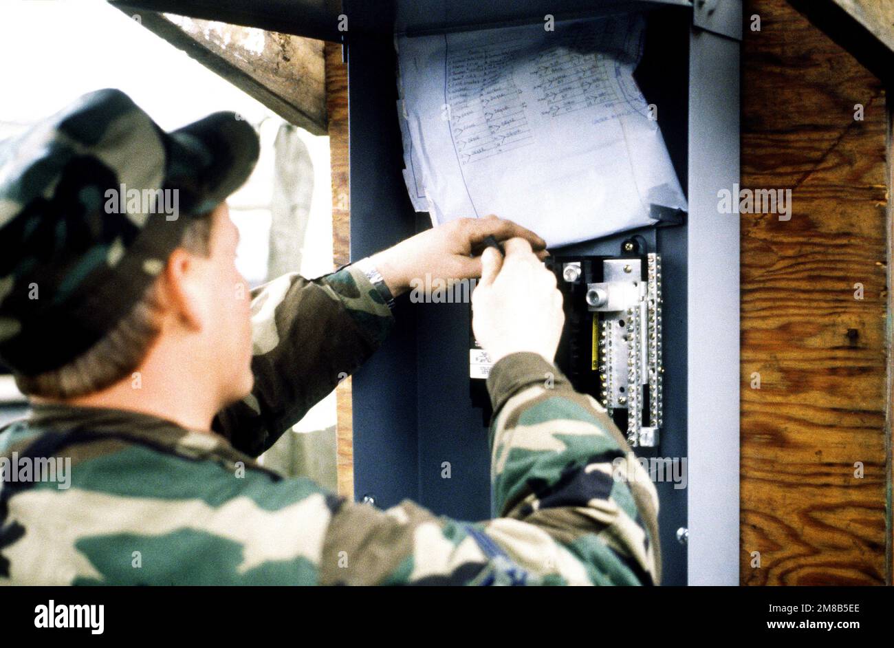 A member of a Prime Beef construction team works on a circuit breaker ...