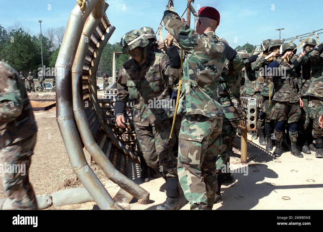A jump master pulls static lines aside as members of the 82nd Airborne ...