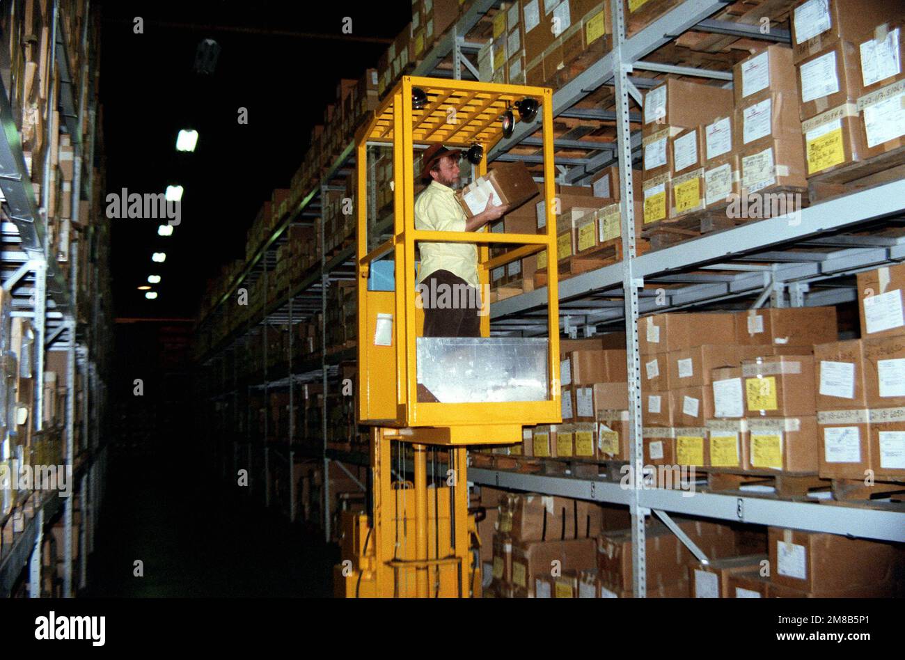Mike Balendy places material in bulk storage in the warehouse facility ...