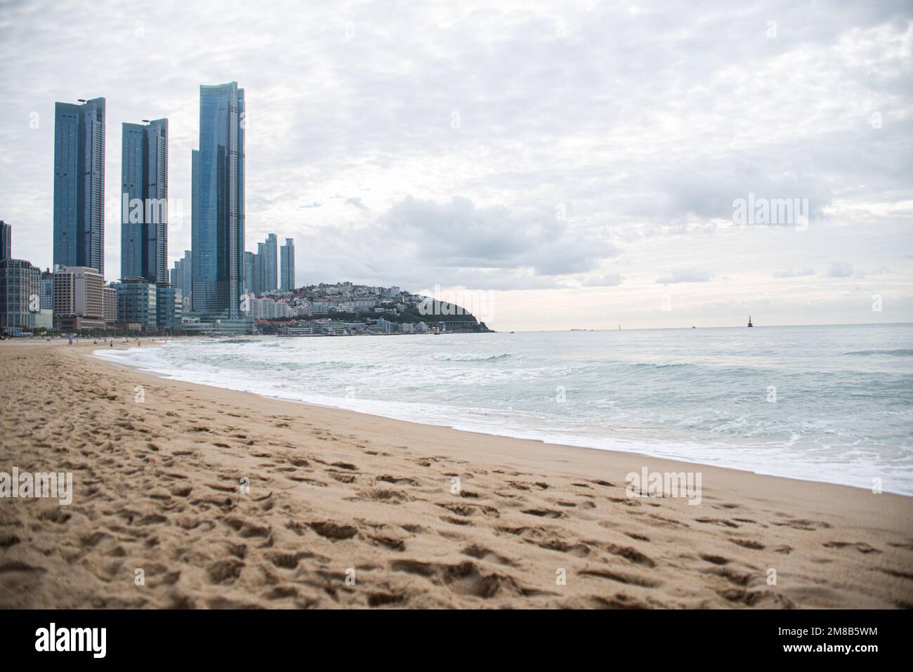 A Haeundae Beach with a sea and tall modern buildings in the background ...