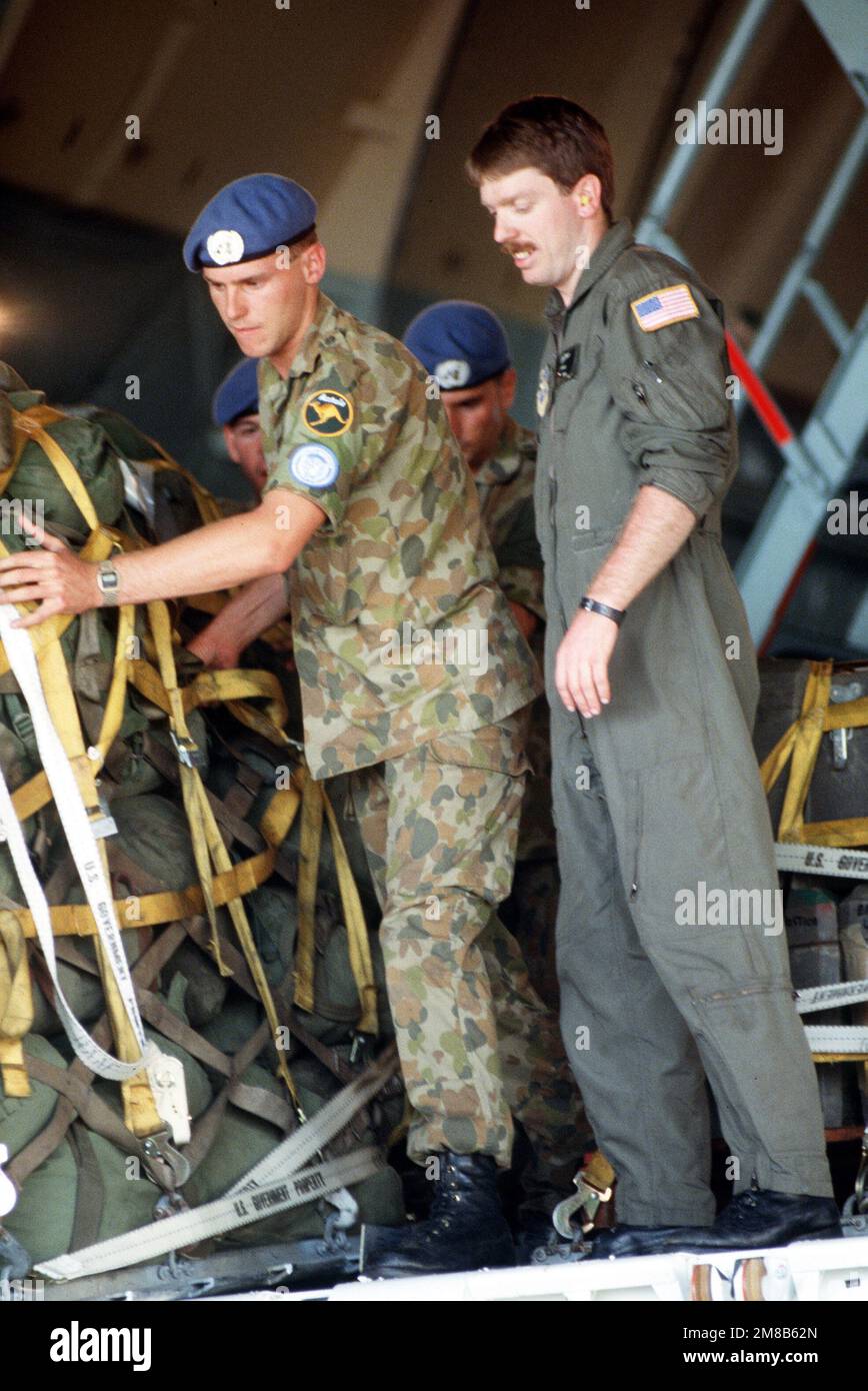 STAFF Sergeant James A. Noble of the 9th Military Airlift Squadron helps Australian troops to ...