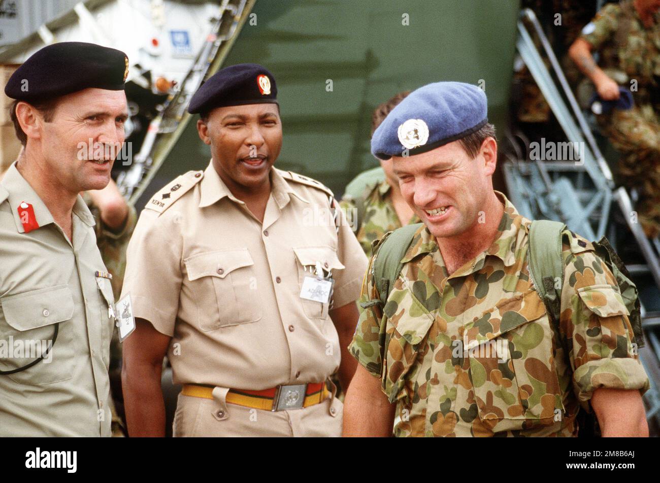 LTC Kevin Pippard, right, is met by LTC Frank Mwangangi, center, of the ...