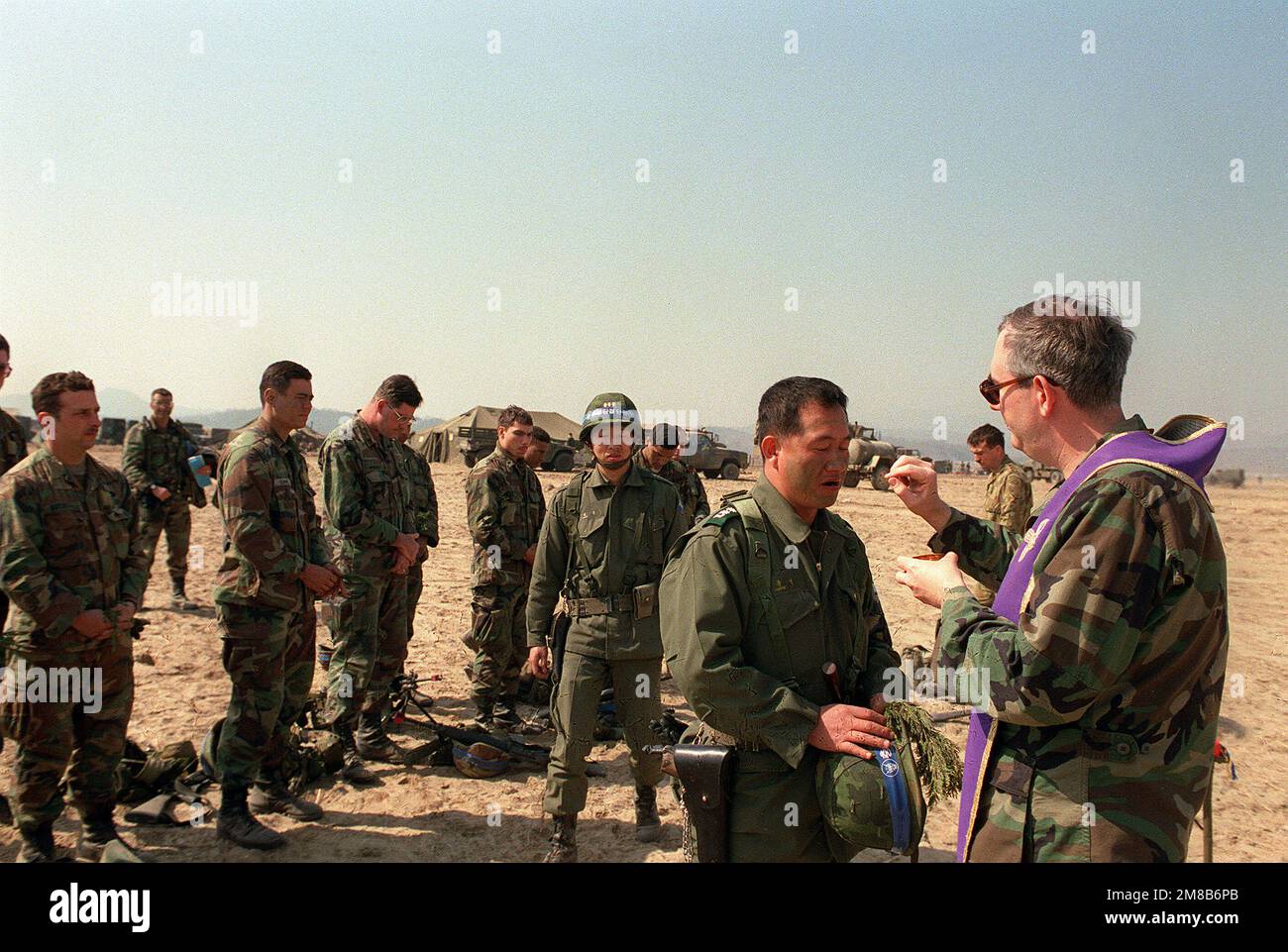A South Korean soldier receives Holy Communion at an outdoor Catholic ...