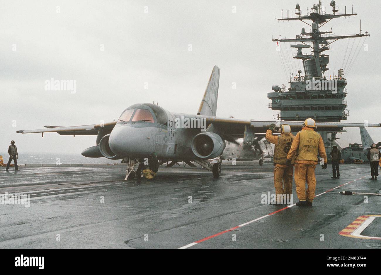 A catapult crewman helps prepare an Air Anti-submarine Squadron 30 (VS ...