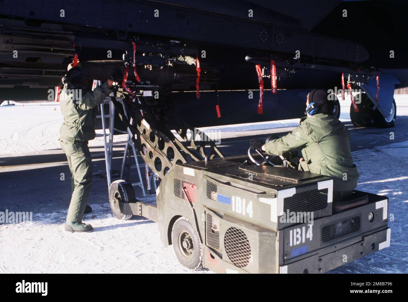 A member of the 5th Munitions Maintenance Squadron use an MJ-1 bomb ...