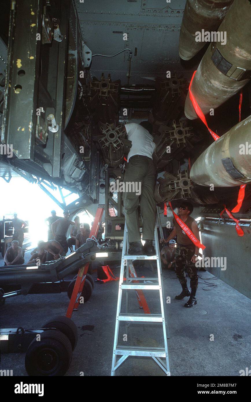 Members of the 43rd Bombardment Wing munitions loading team watch as ...