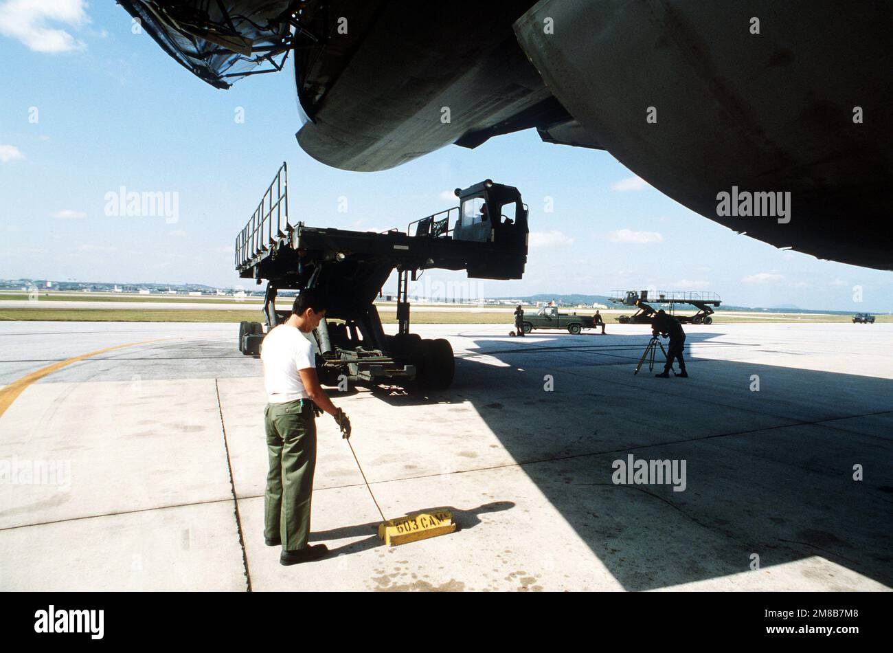 An airman from the 603rd Military Airlift Support Group moves a wheel ...
