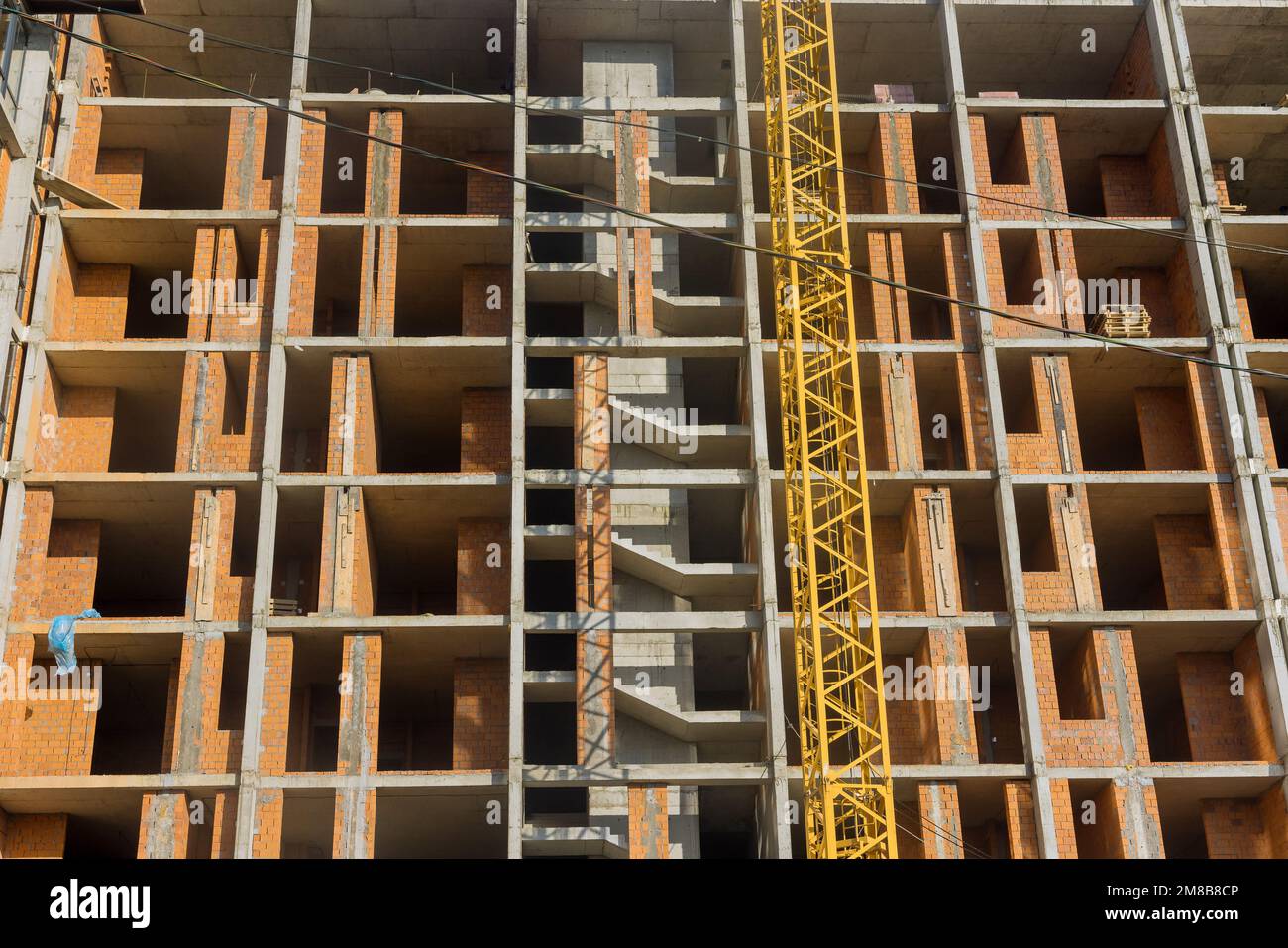 Multi storied apartment building is being constructed along in progress ...