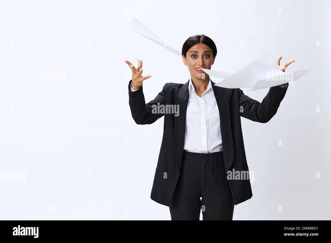 Business woman throwing papers documents in black business suit showing ... Business woman throwing papers documents in black business suit showing ...