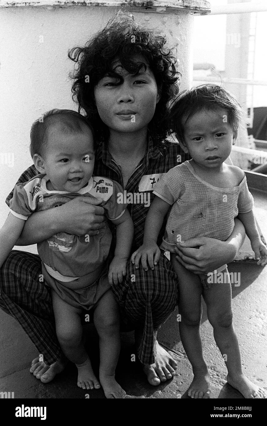 A Vietnamese refugee mother poses for a photograph with her children ...