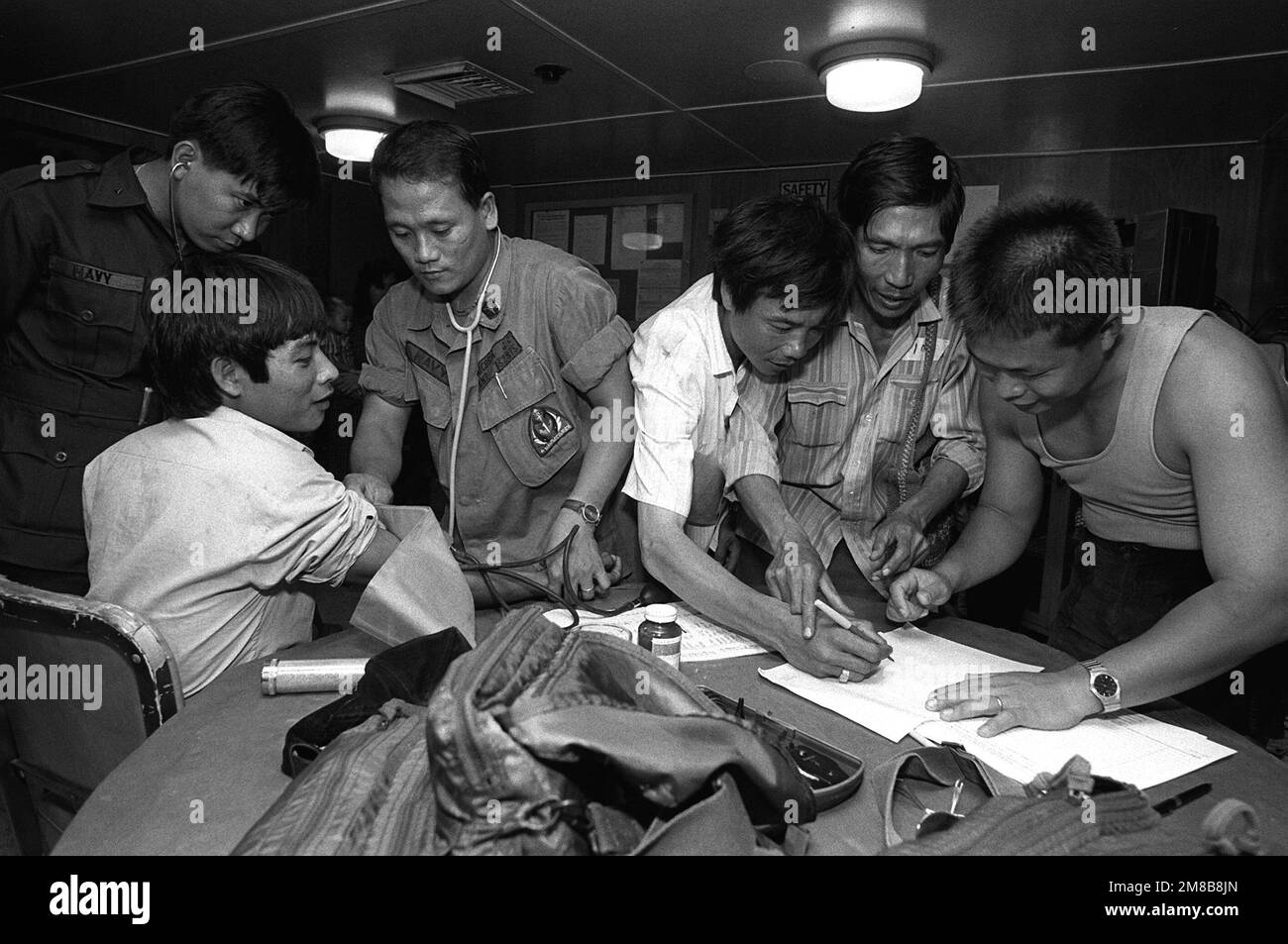 A Vietnamese refugee is examined by Philippine naval medical personnel ...