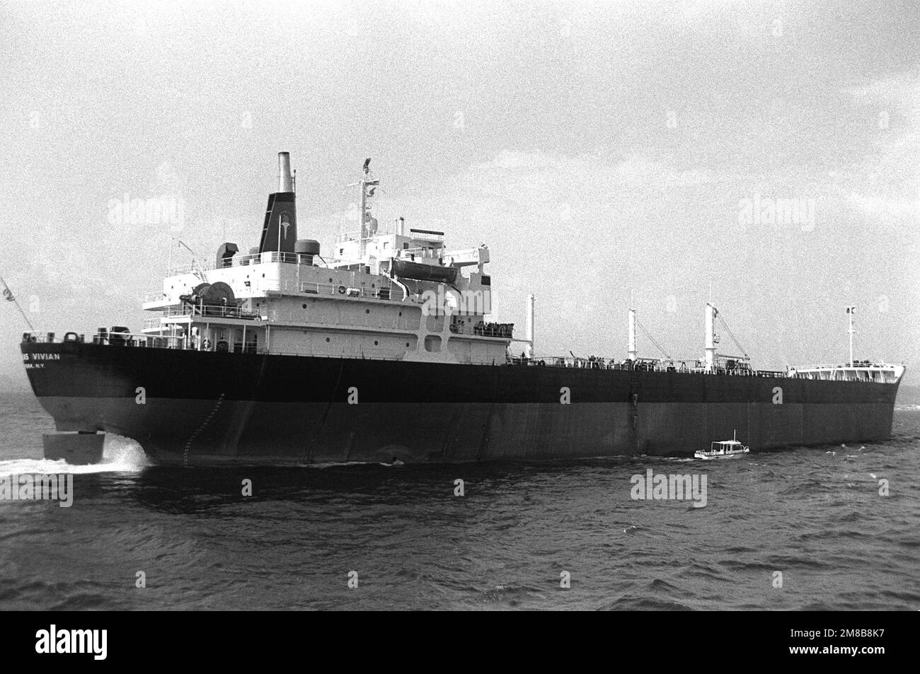 A launch is dwarfed alongside the petroleum tanker OVERSEAS VIVIAN (T ...