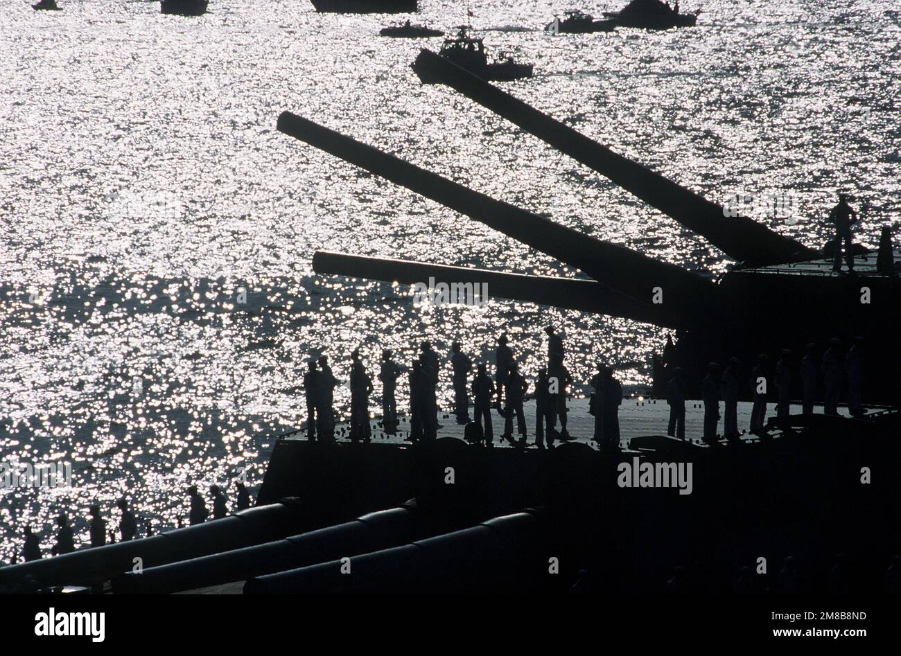 Crew members and 16-inch guns of the battleship USS Iowa (BB-61) are ...