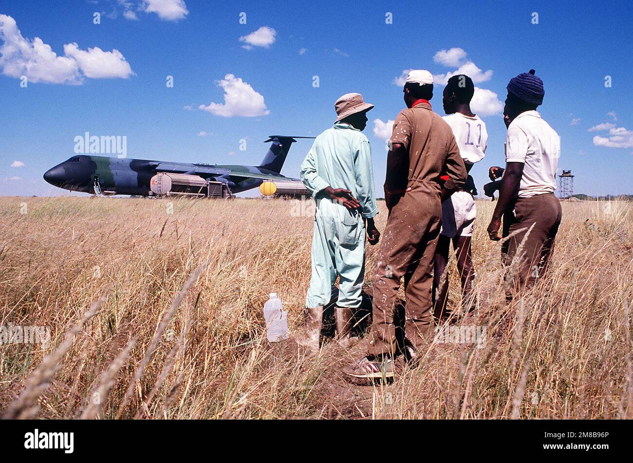 Namibian workers watch operations following the landing of a Military ...