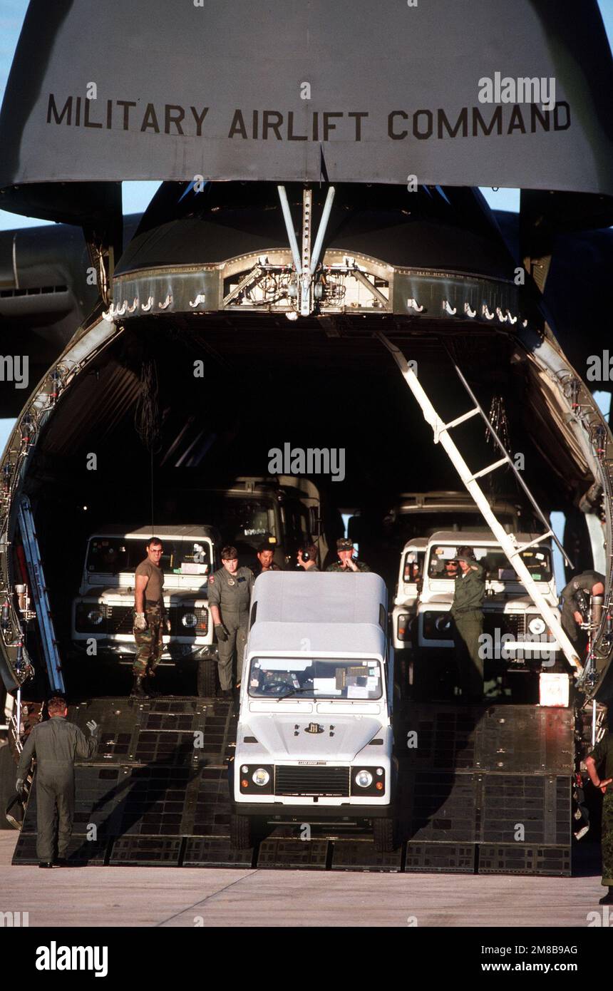 British Land Rovers are offloaded from a Military Airlift Command C-5B ...