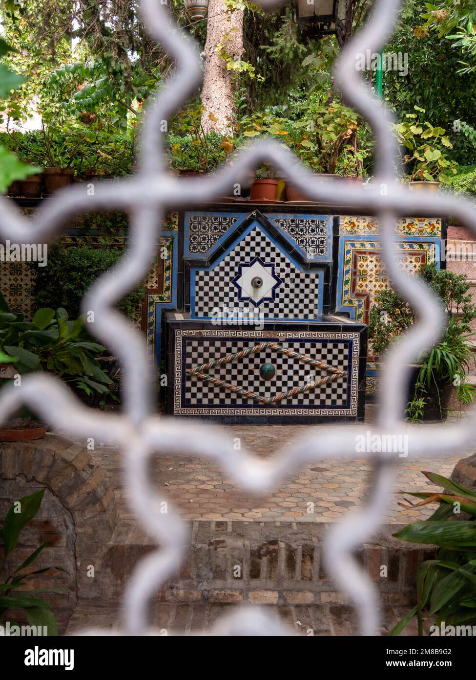 A vertical shot of an Arabic-style water fountain seen from the wire ...