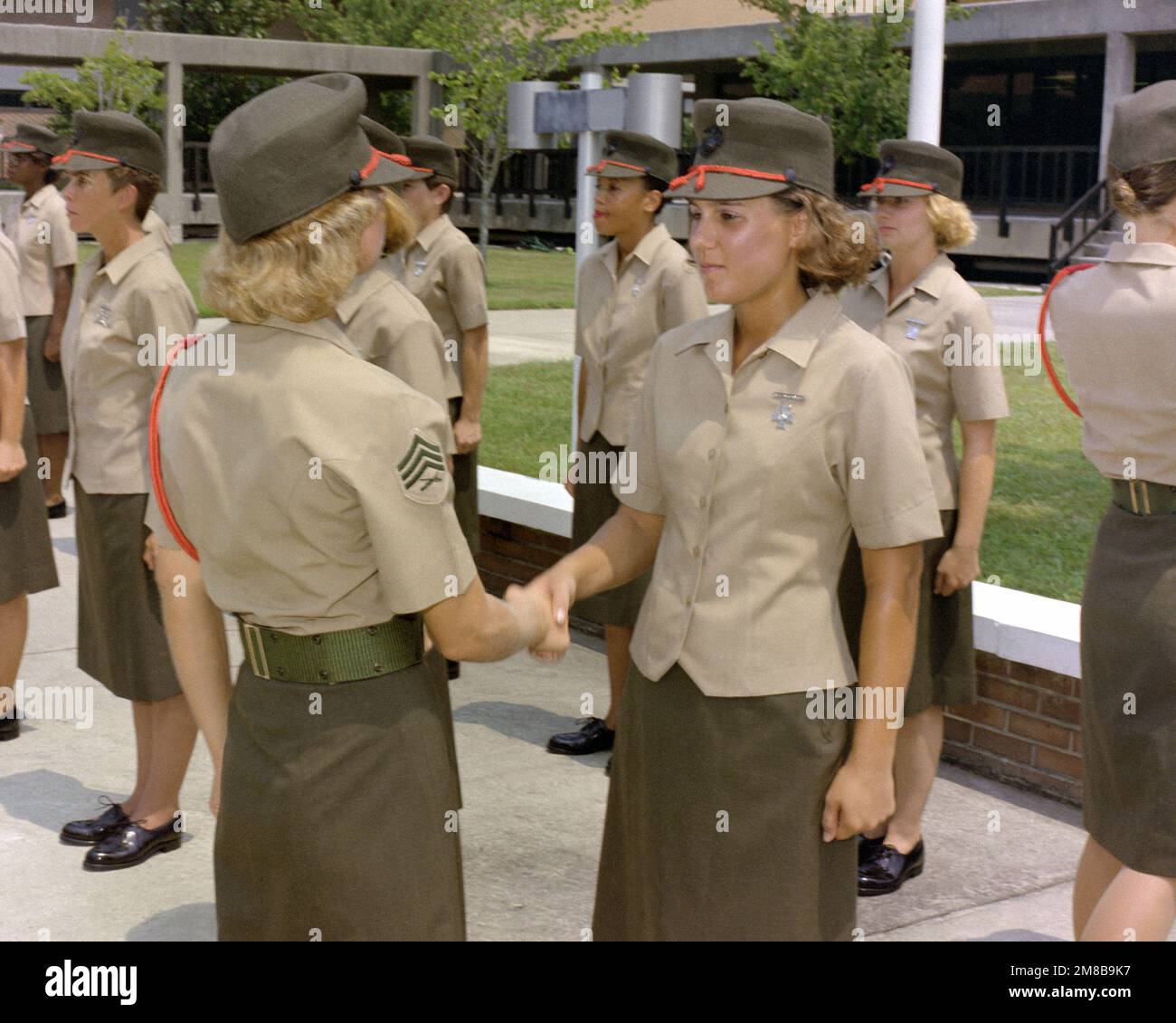 A graduating 4th Battalion recruit and her drill instructor take part ...