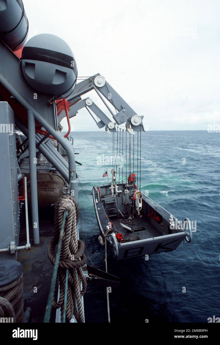 A 35-foot work boat is lowered from the port side of the salvage and ...