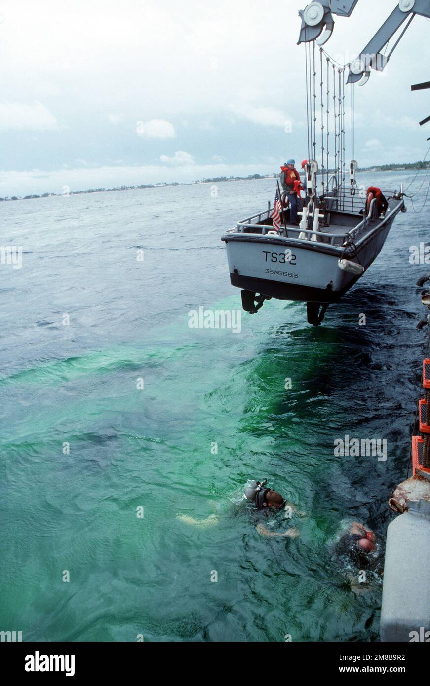 During operations near Majuro Atoll, divers swim beside the salvage and ...