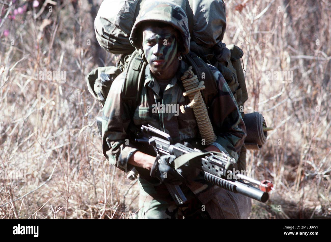 A Marine grenadier carries his gear during Team Spirit '89. He is armed ...