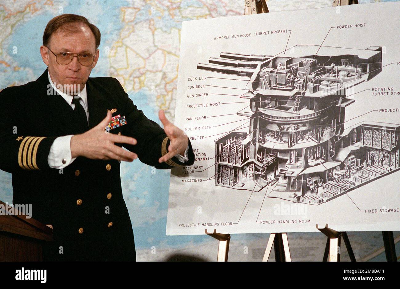 Using a diagram of a 16-inch gun turret, Captain Larry Seaquist briefs ...