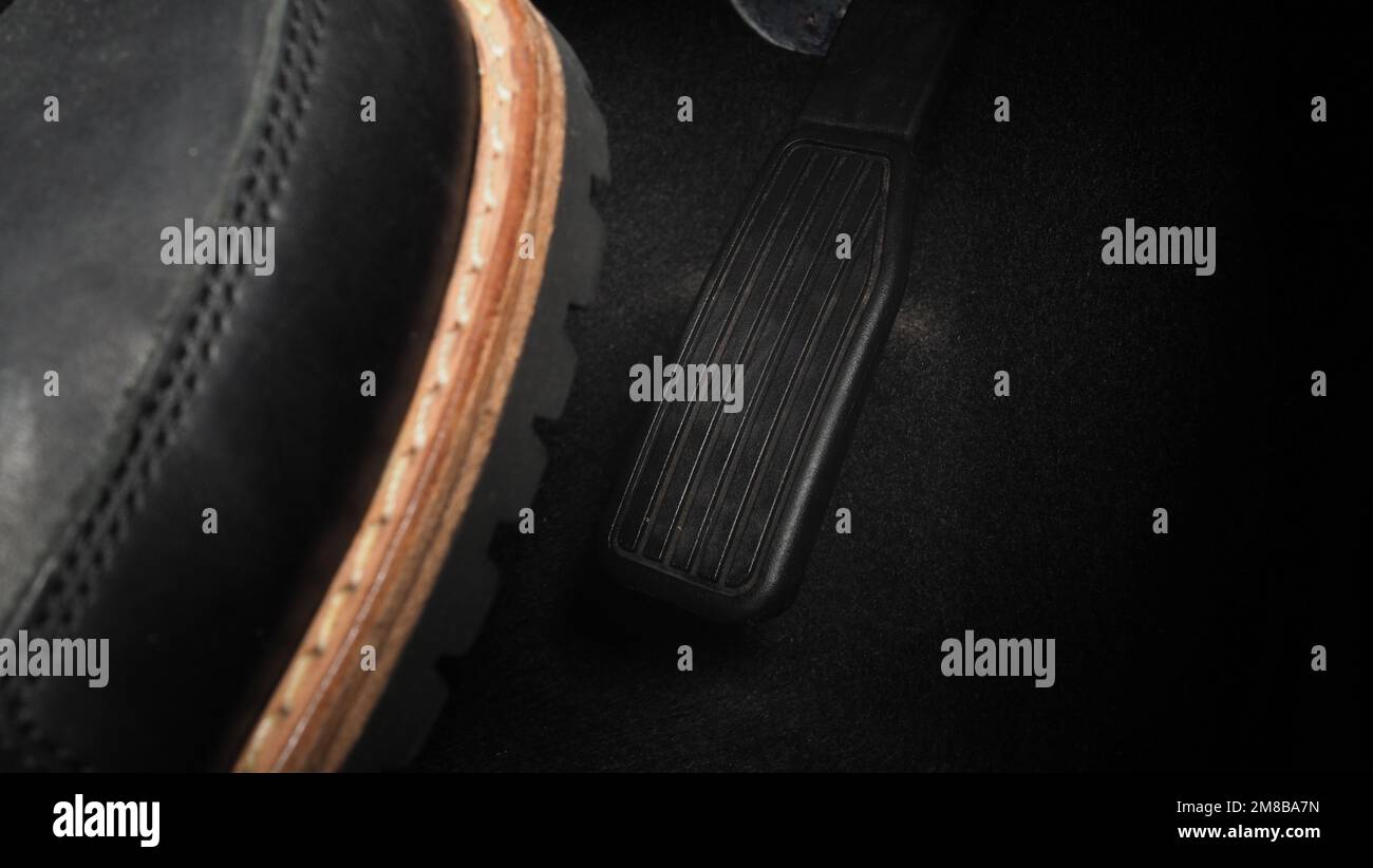Car accelerate and brake foot pedal. Close up foot press or push foot ...