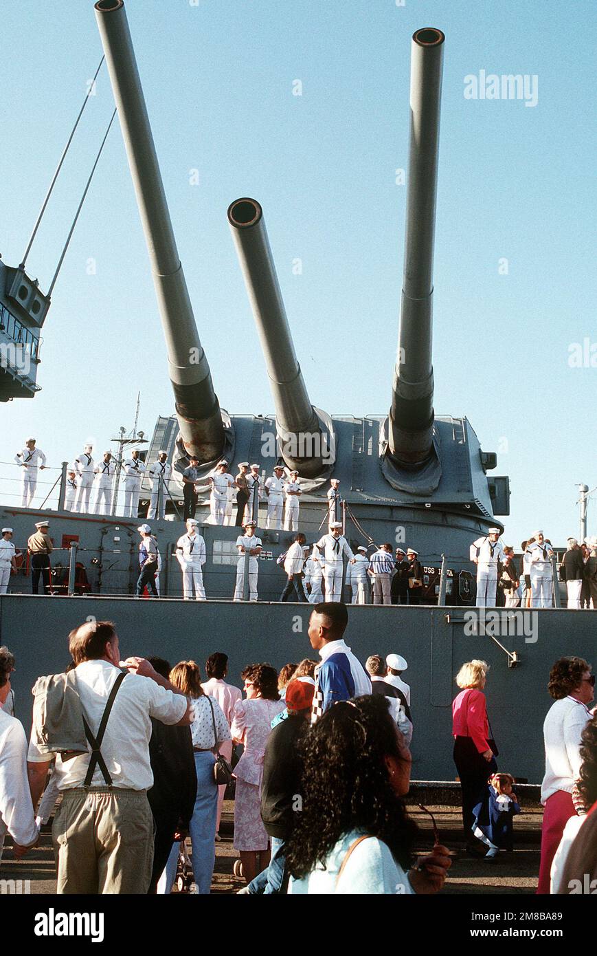 The 16-inch guns aboard the battleship USS IOWA (BB-61) loom over crew ...