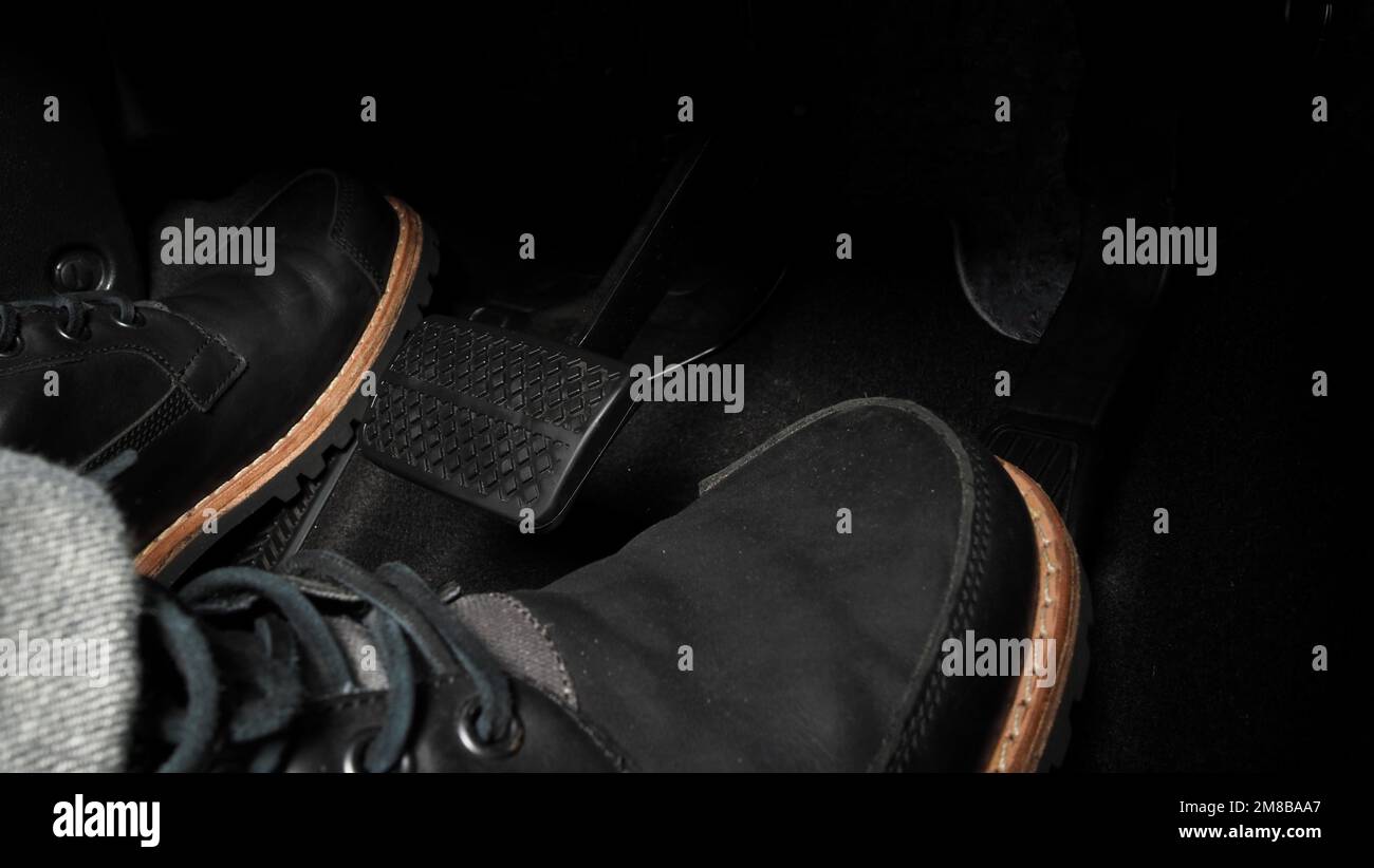 Car accelerate and brake foot pedal. Close up foot press or push foot ...