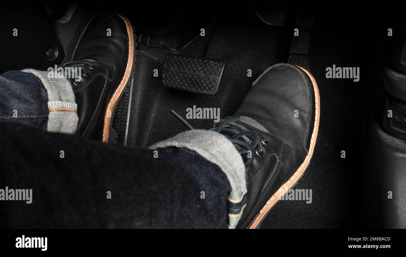 Car accelerate and brake foot pedal. Close up foot press or push foot ...