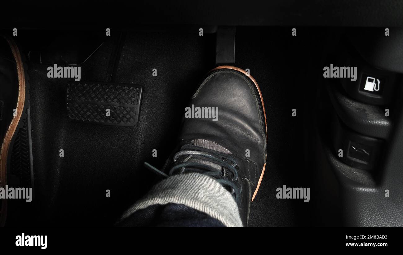 Car accelerate and brake foot pedal. Close up foot press or push foot ...