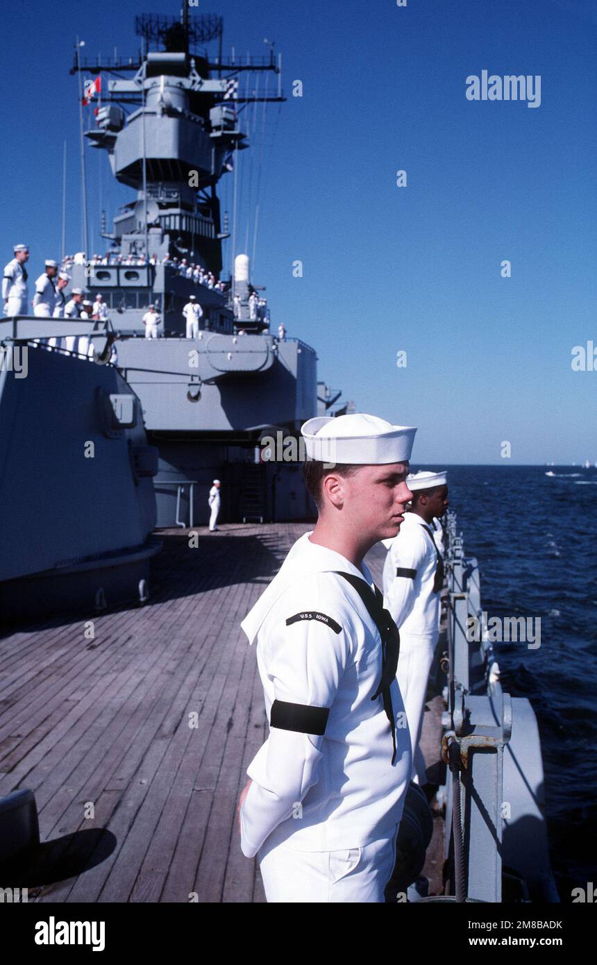 Crew members man the rails aboard the battleship USS IOWA (BB-61) as ...